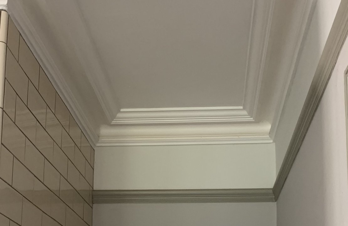 How can wooden picture rails add a decorative element to any home?