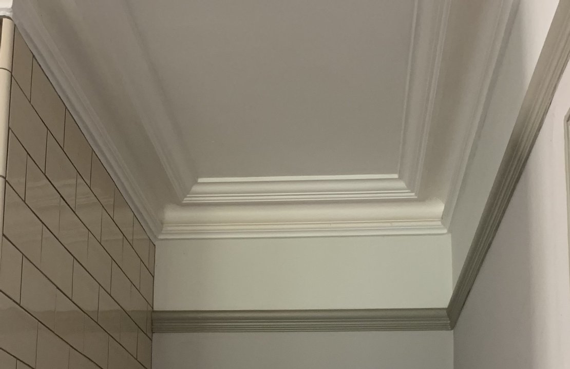 How can wooden picture rails add a decorative element to any home?